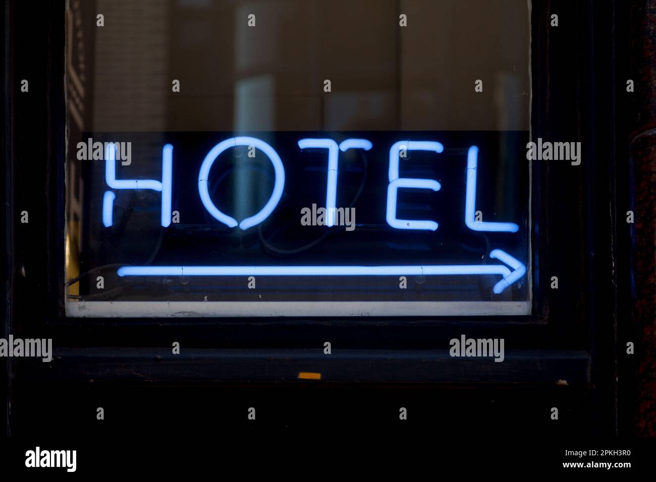 Neon light shaped into the word "hotel" above an arrow Stock Photo - Alamy