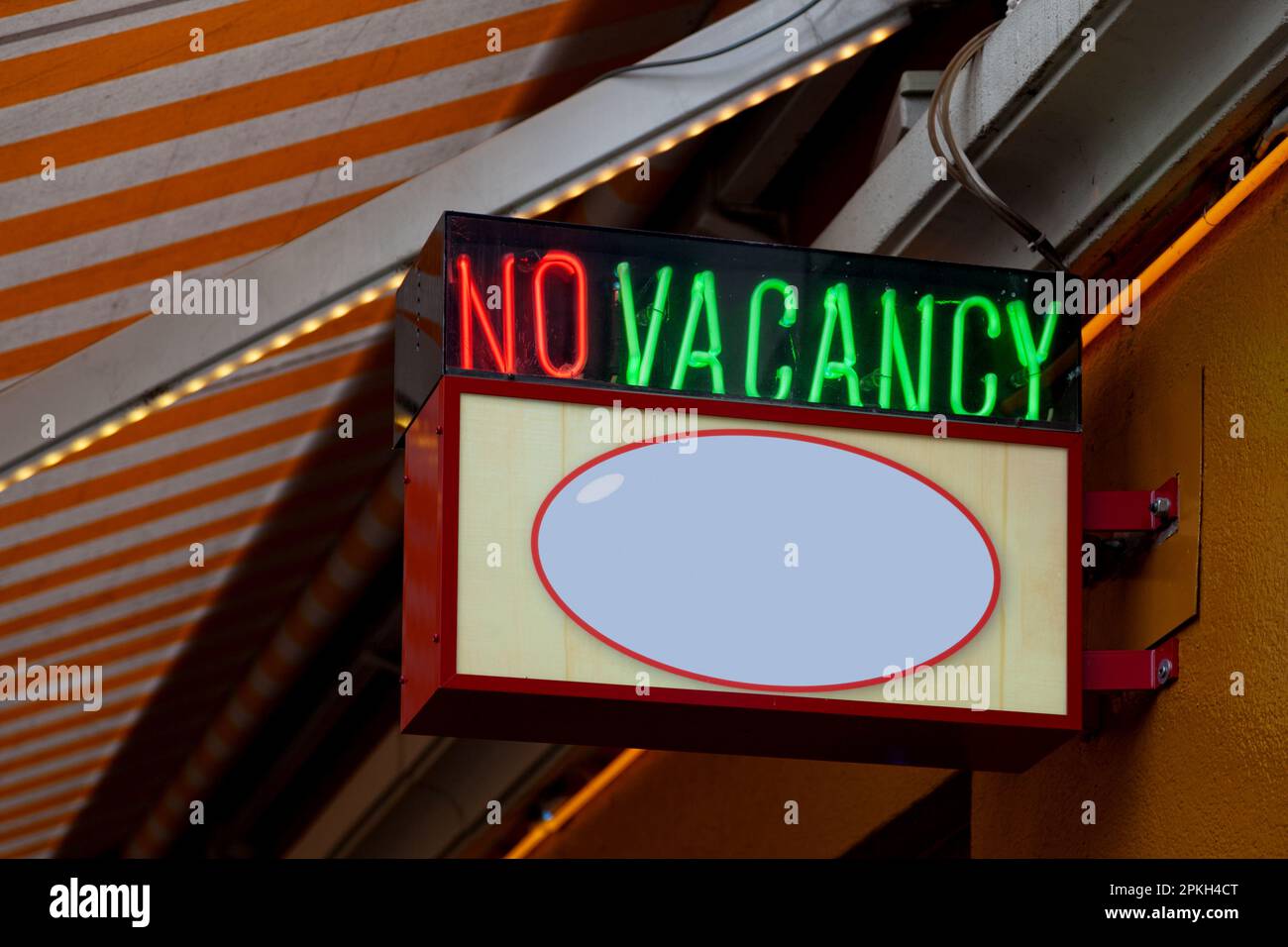 Hotel sign displaying a neon "No vacancy" with a copy scape bellow ...