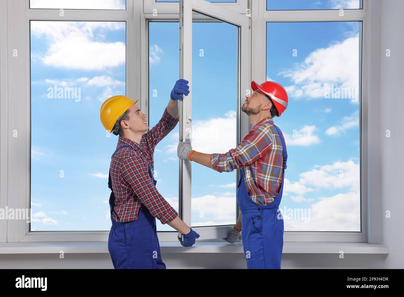 Young workers installing new hi-res stock photography and images - Alamy