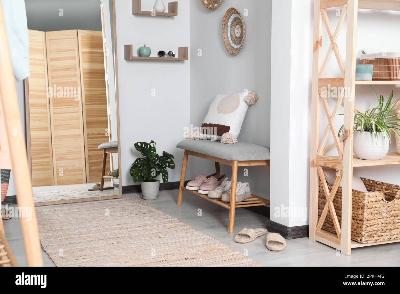 Hallway interior with shoe storage bench and floor mirror Stock Photo ...
