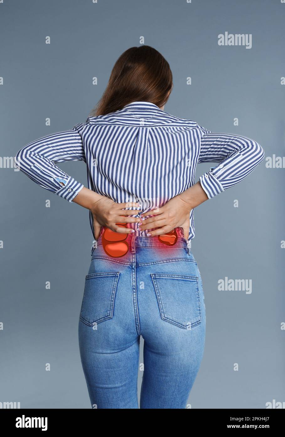 Woman suffering from kidney pain on grey background Stock Photo - Alamy