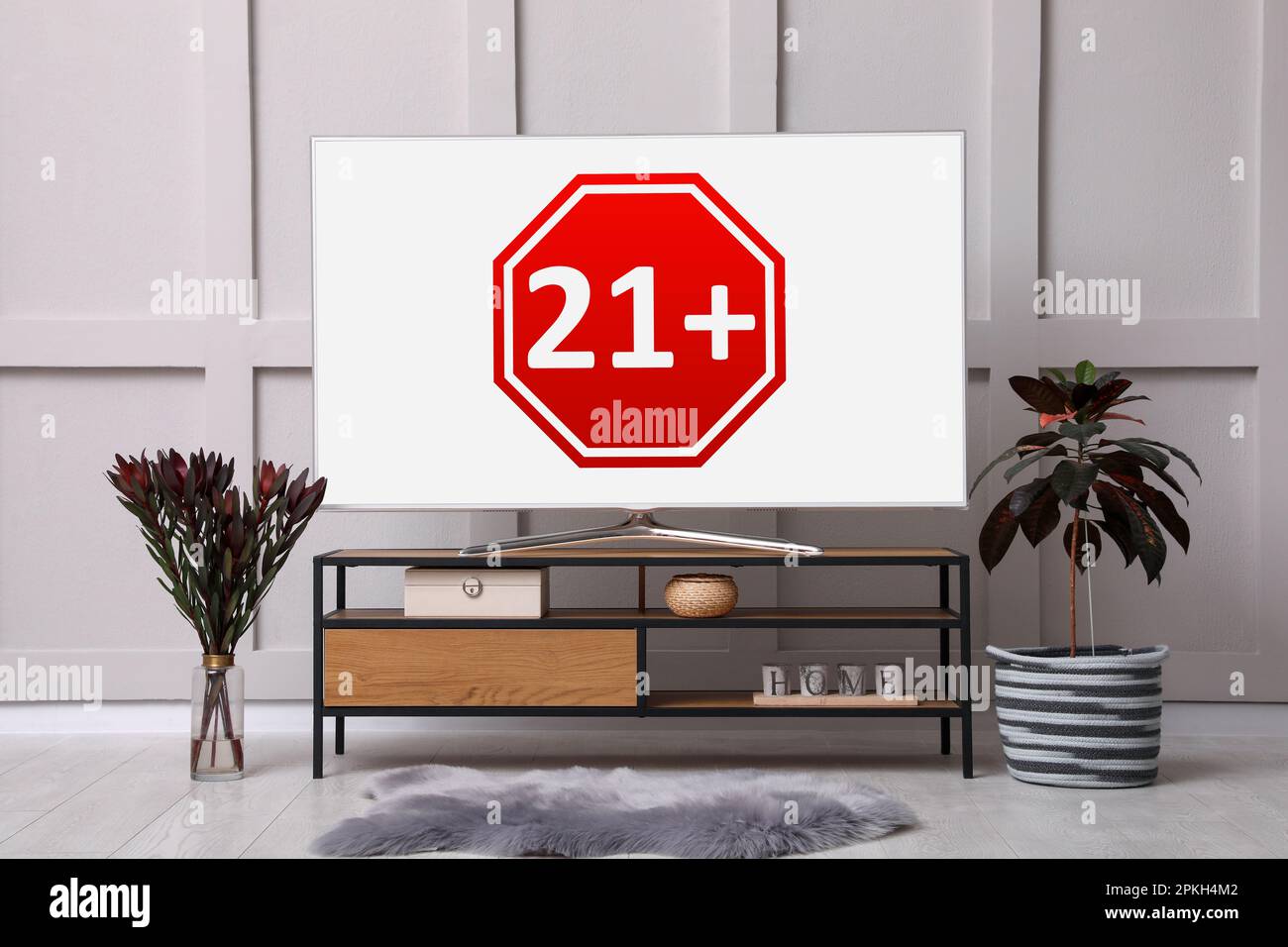 TV screen with age limit sign 18+ years on wooden cabinet with indoors ...