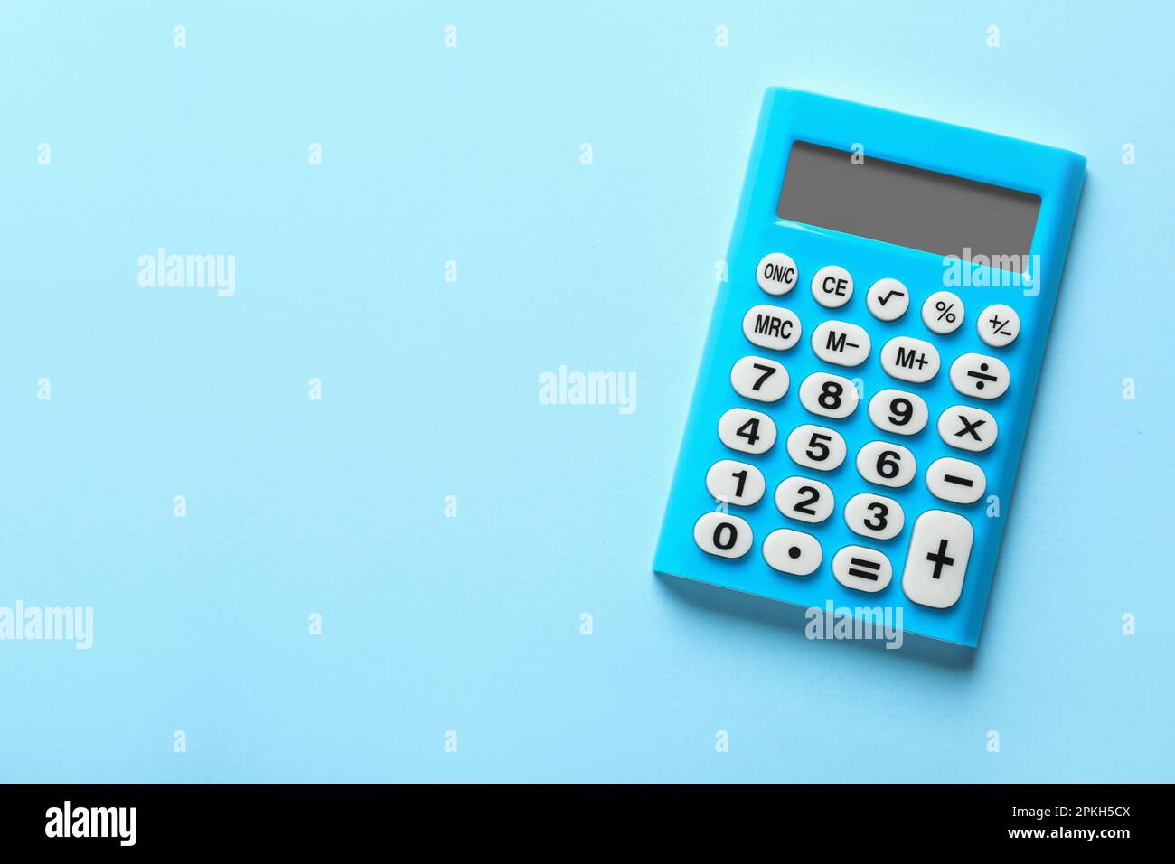 Light blue calculator on turquoise background, top view. Space for text ...