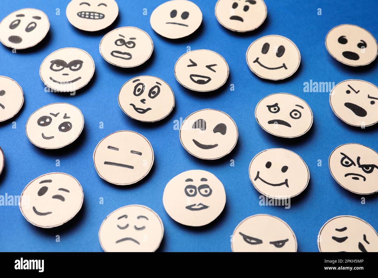 Many faces with different emotions on blue background Stock Photo - Alamy