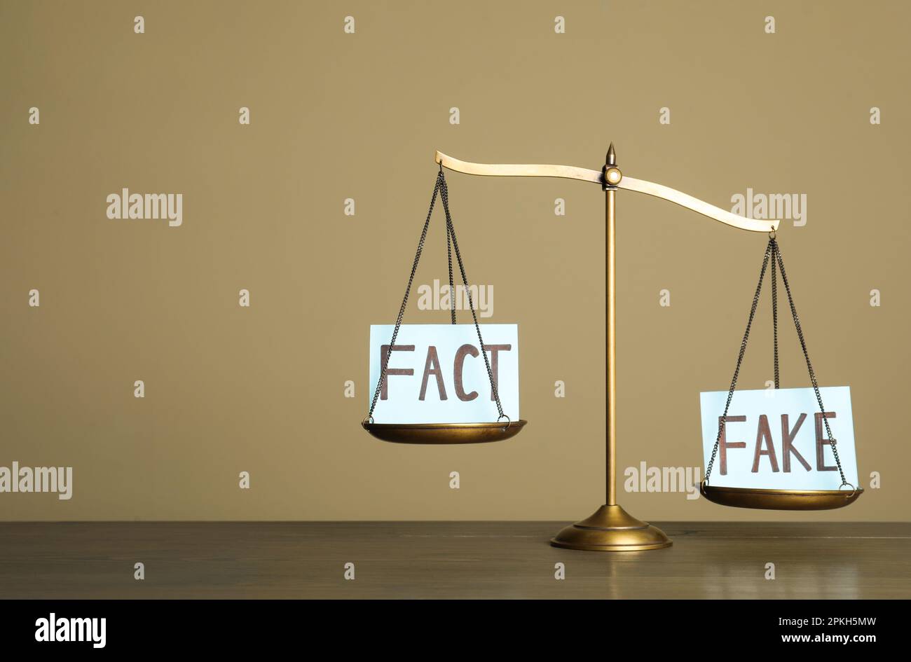 Scales with words FACT and FAKE on wooden table, space for text Stock ...