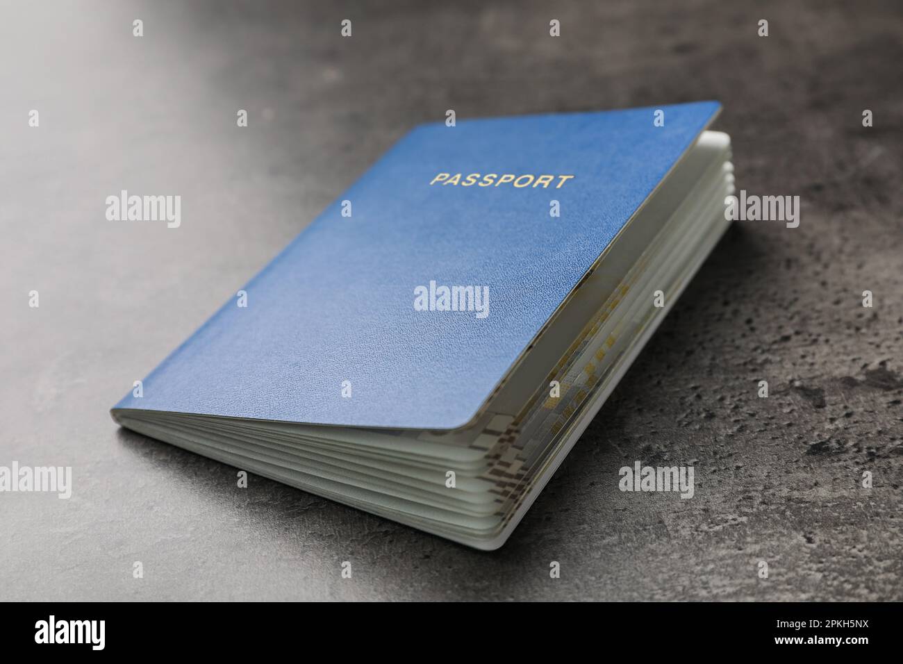 Blank blue passport on dark grey table, closeup Stock Photo - Alamy
