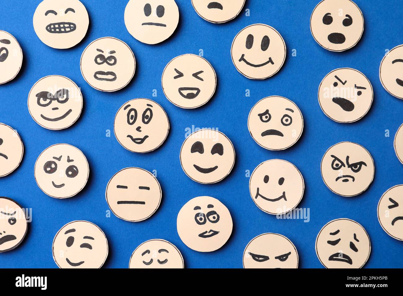 Many faces with different emotions on blue background, flat lay Stock ...