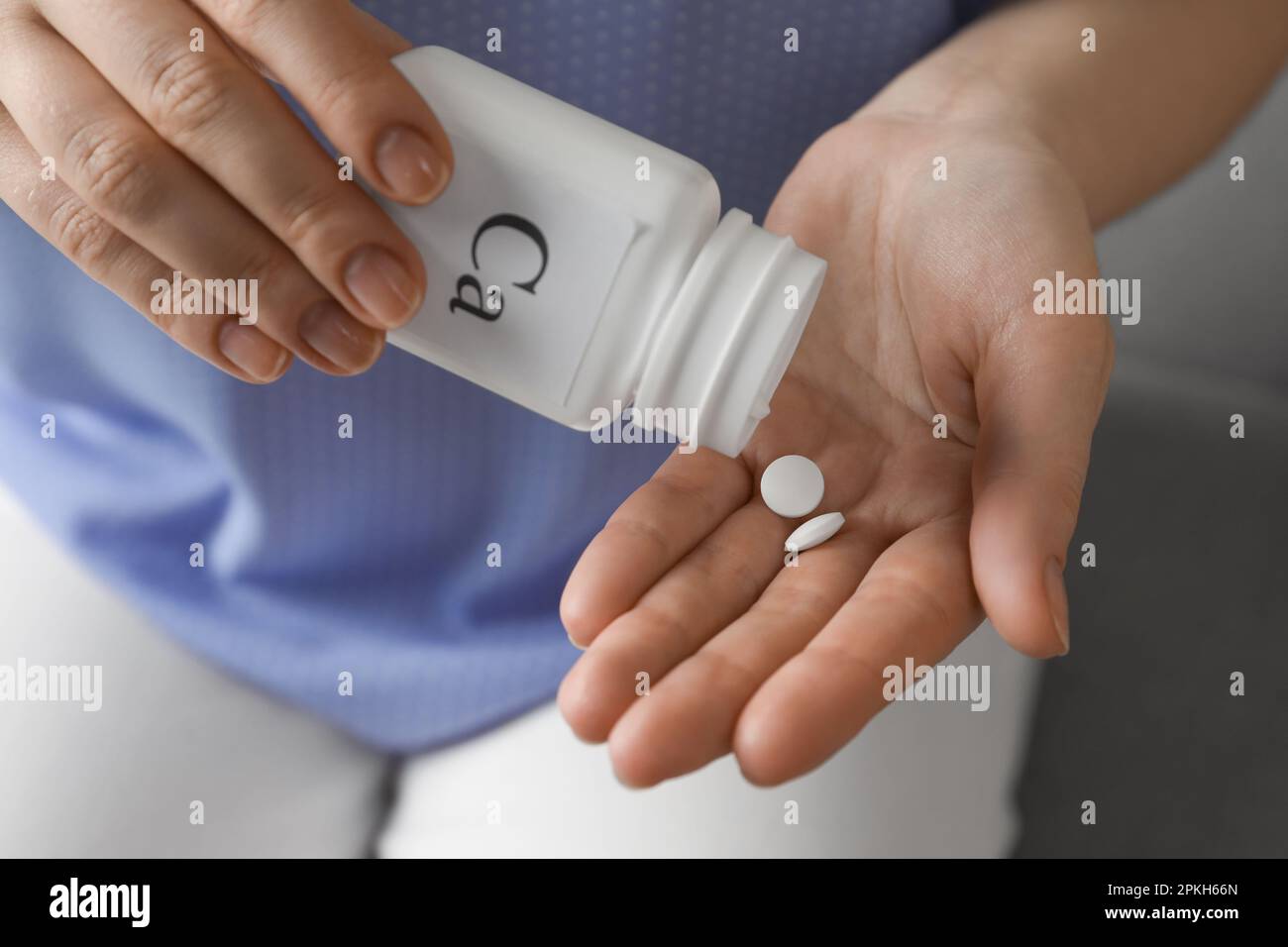 Calcium supplement. Woman taking pills indoors, closeup Stock Photo - Alamy