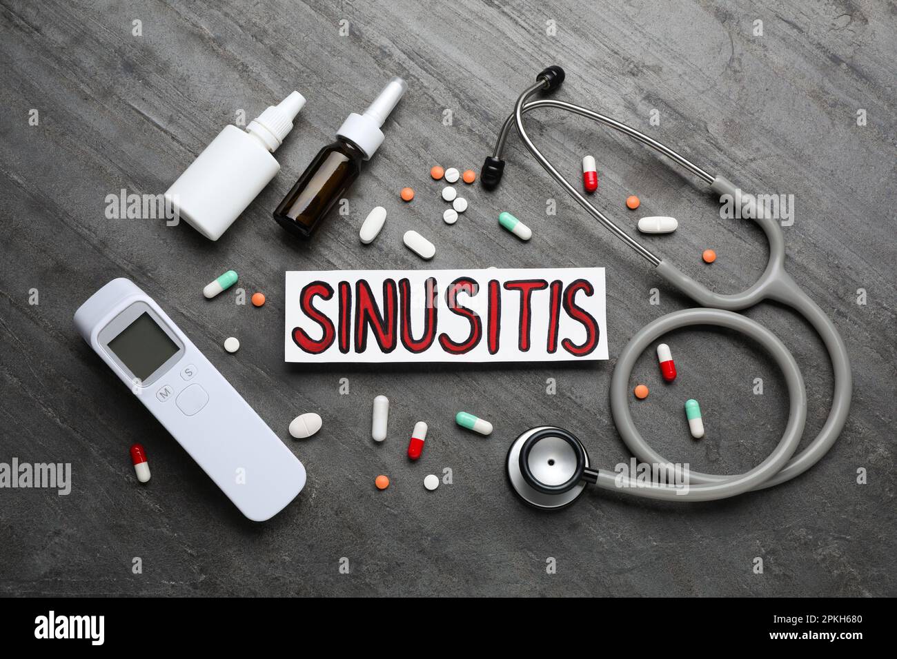 Card with word SINUSITIS, stethoscope, non-contact thermometer and ...