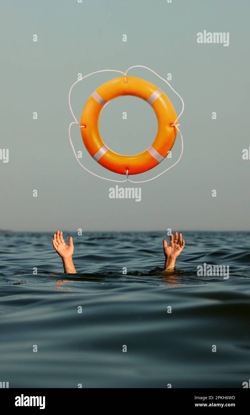 Drowning man with raised hands getting lifebelt in sea Stock Photo - Alamy