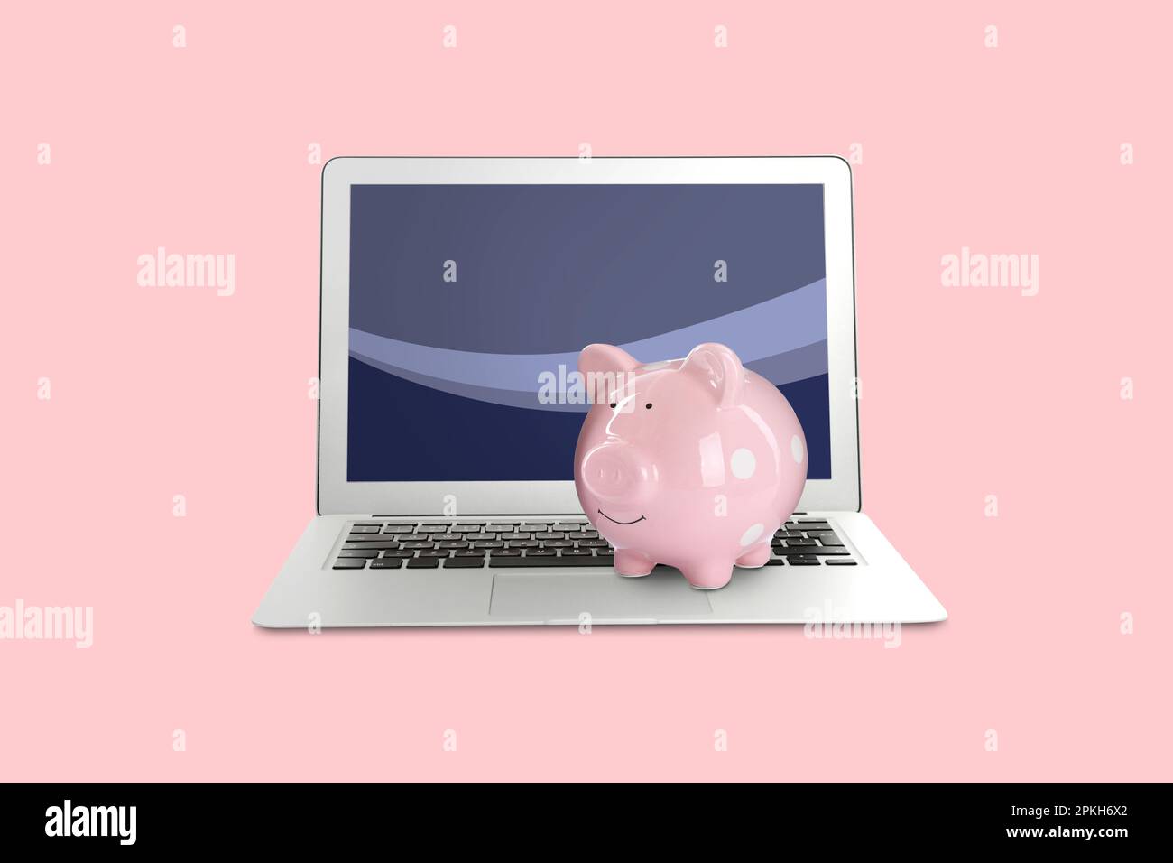 Piggy bank and laptop on pink background. Online banking Stock Photo ...