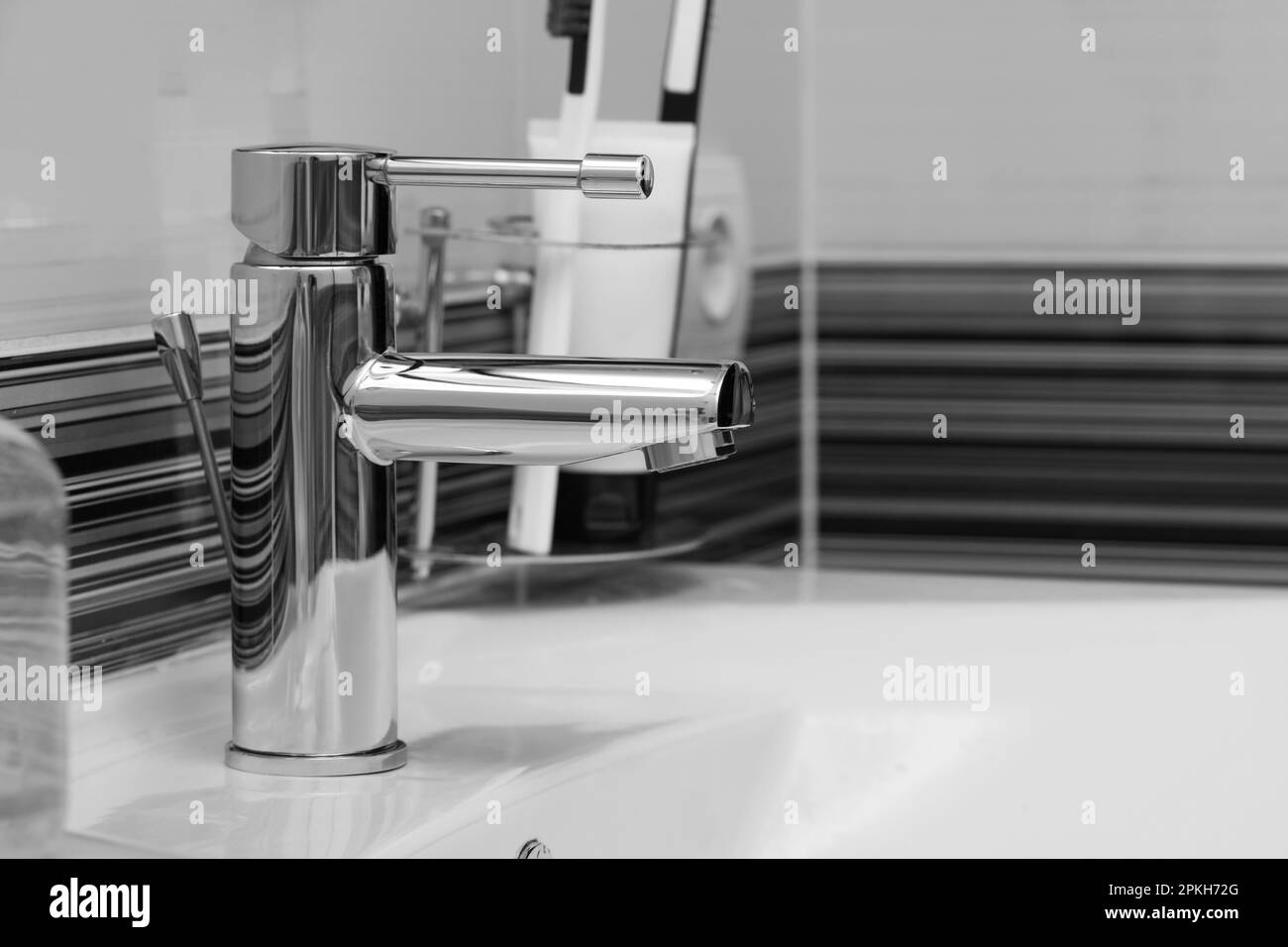 Clean white sink with shiny water tap in bathroom Stock Photo - Alamy