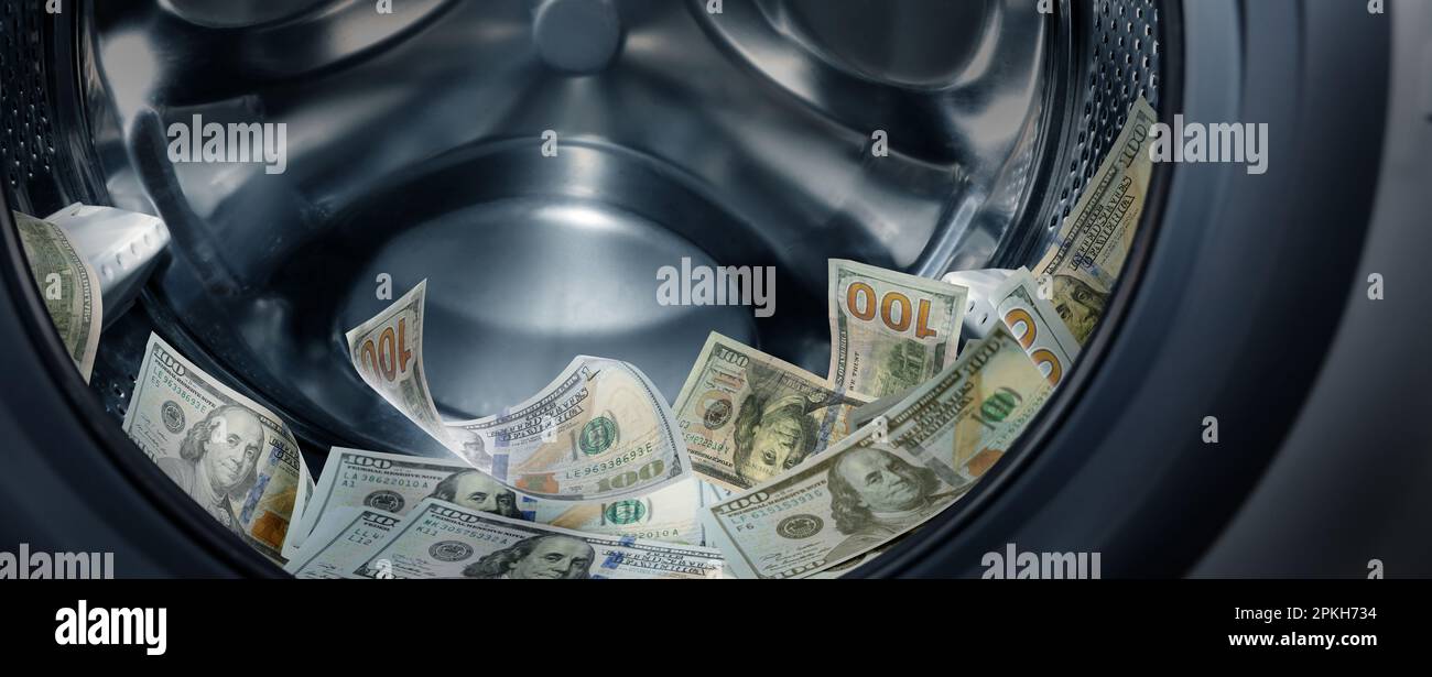 Money laundering. Many dollar banknotes in washing machine, banner ...