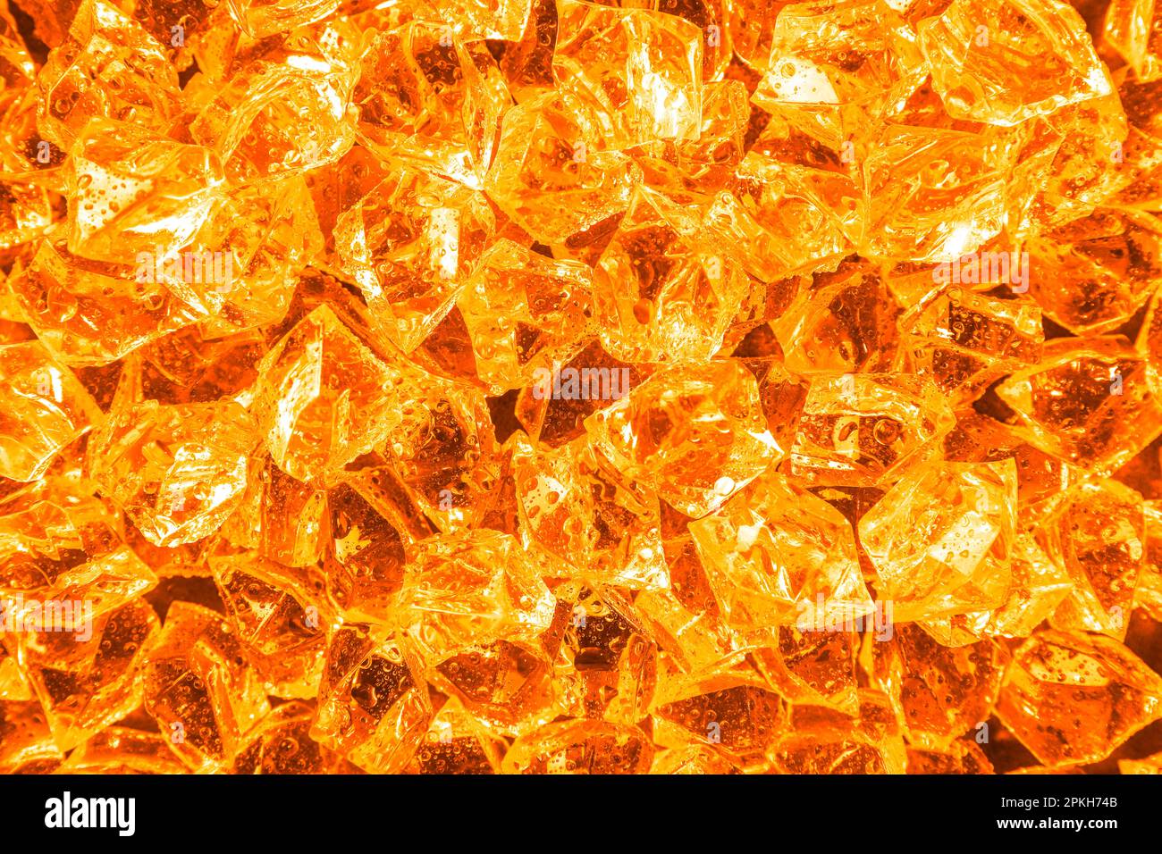 Pile of crushed ice as background, top view. Toned in orange color ...