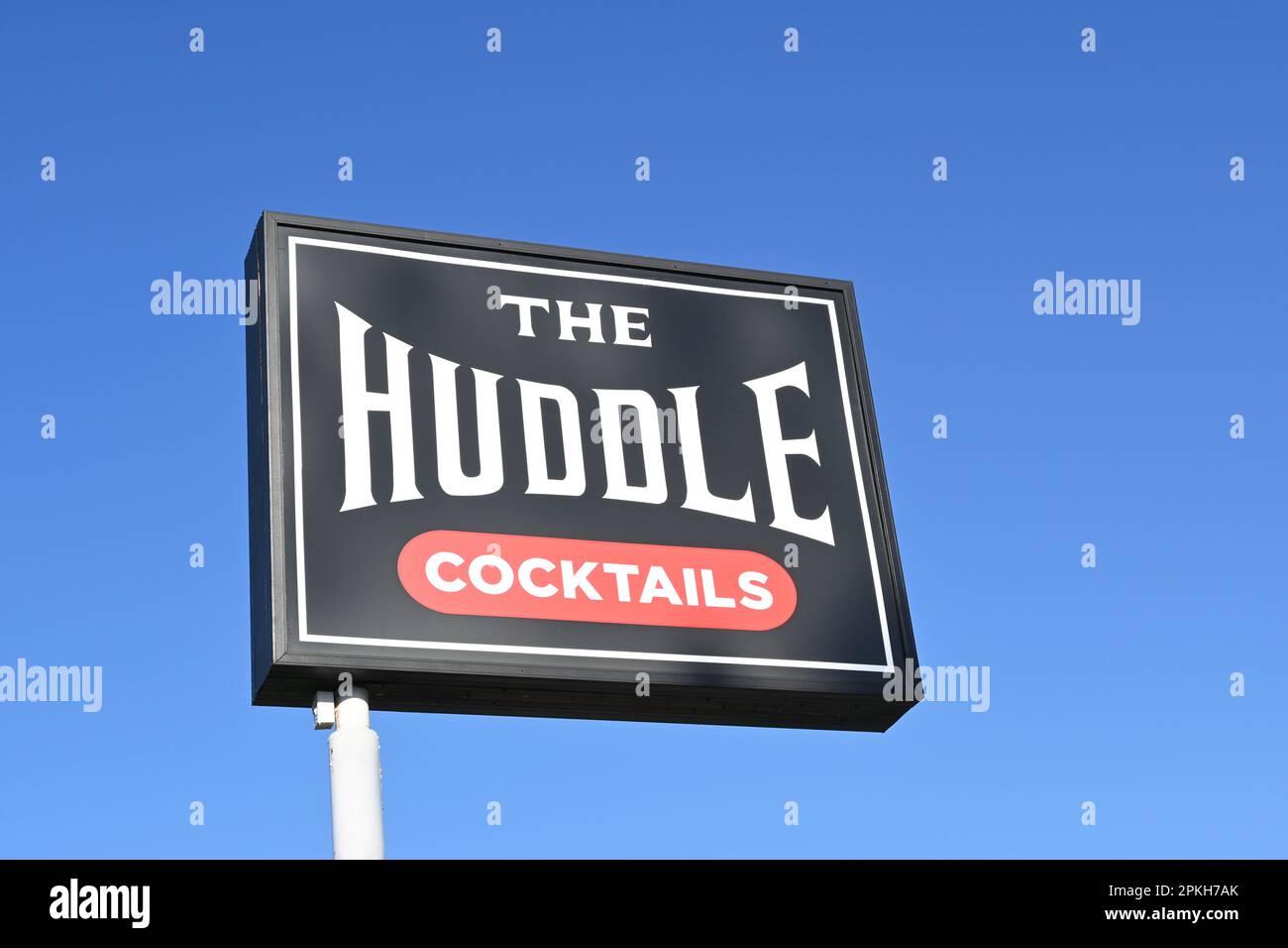 COSTA MESA, CALIFORNIA - 4 APR 2023: Sign for The Huddle a dive bar ... COSTA MESA, CALIFORNIA - 4 APR 2023: Sign for The Huddle a dive bar ...