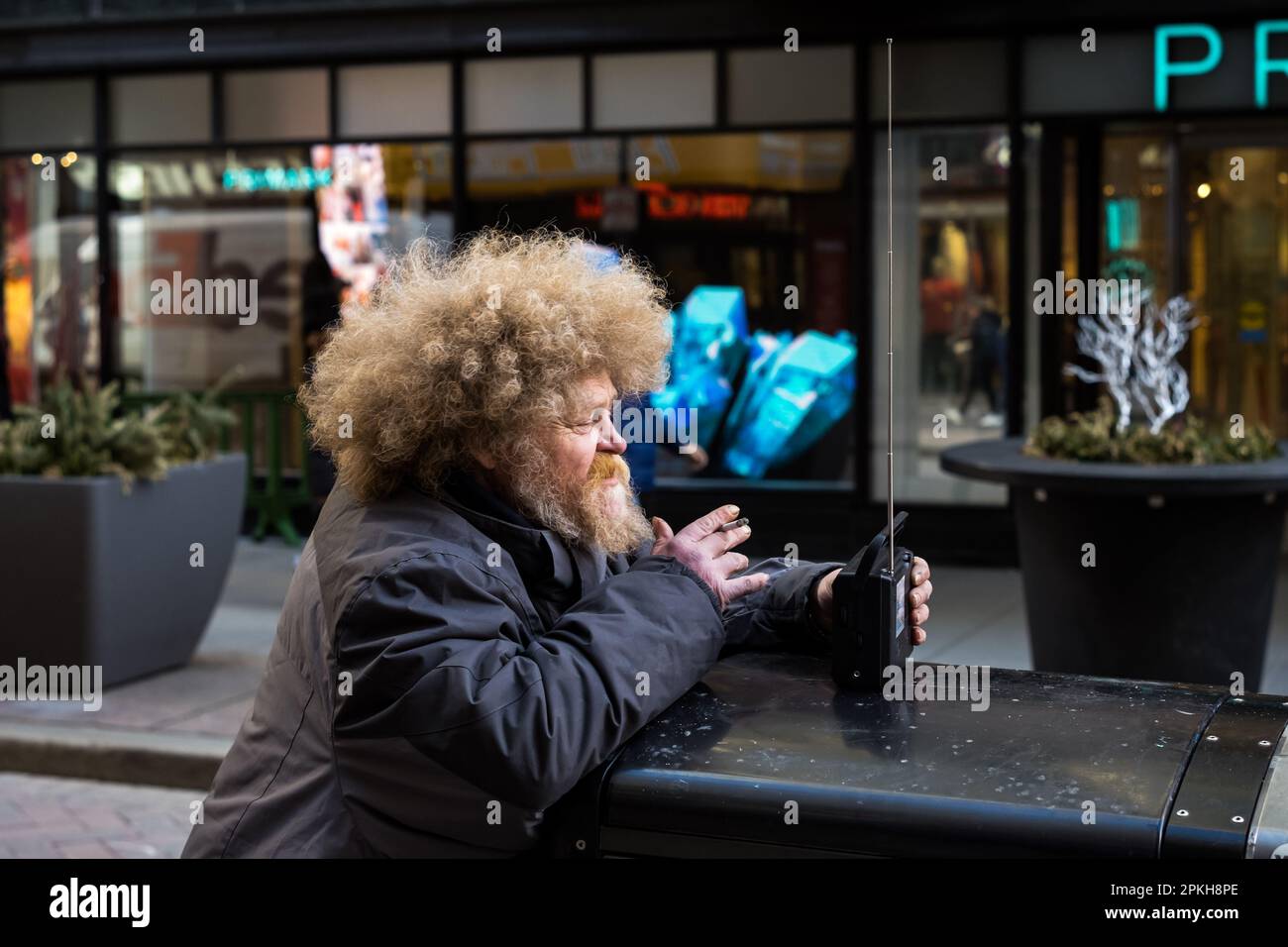 Boston, USA. 8 Mar, 2023. A man smoking a cigarette on a sidewalk with ...