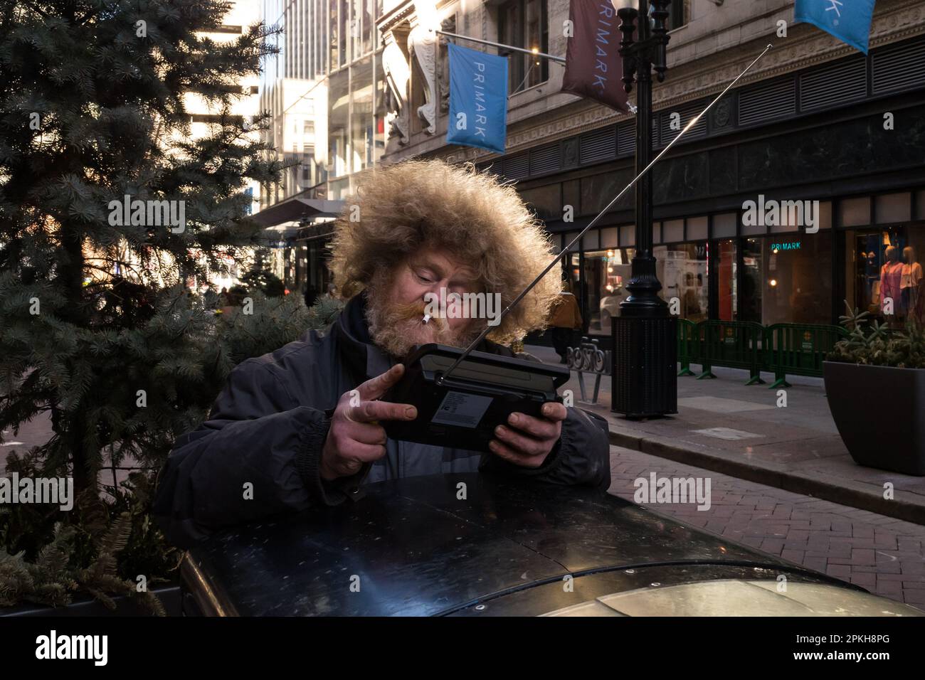 Boston, USA. 8 Mar, 2023. A man smoking a cigarette on a sidewalk with ...