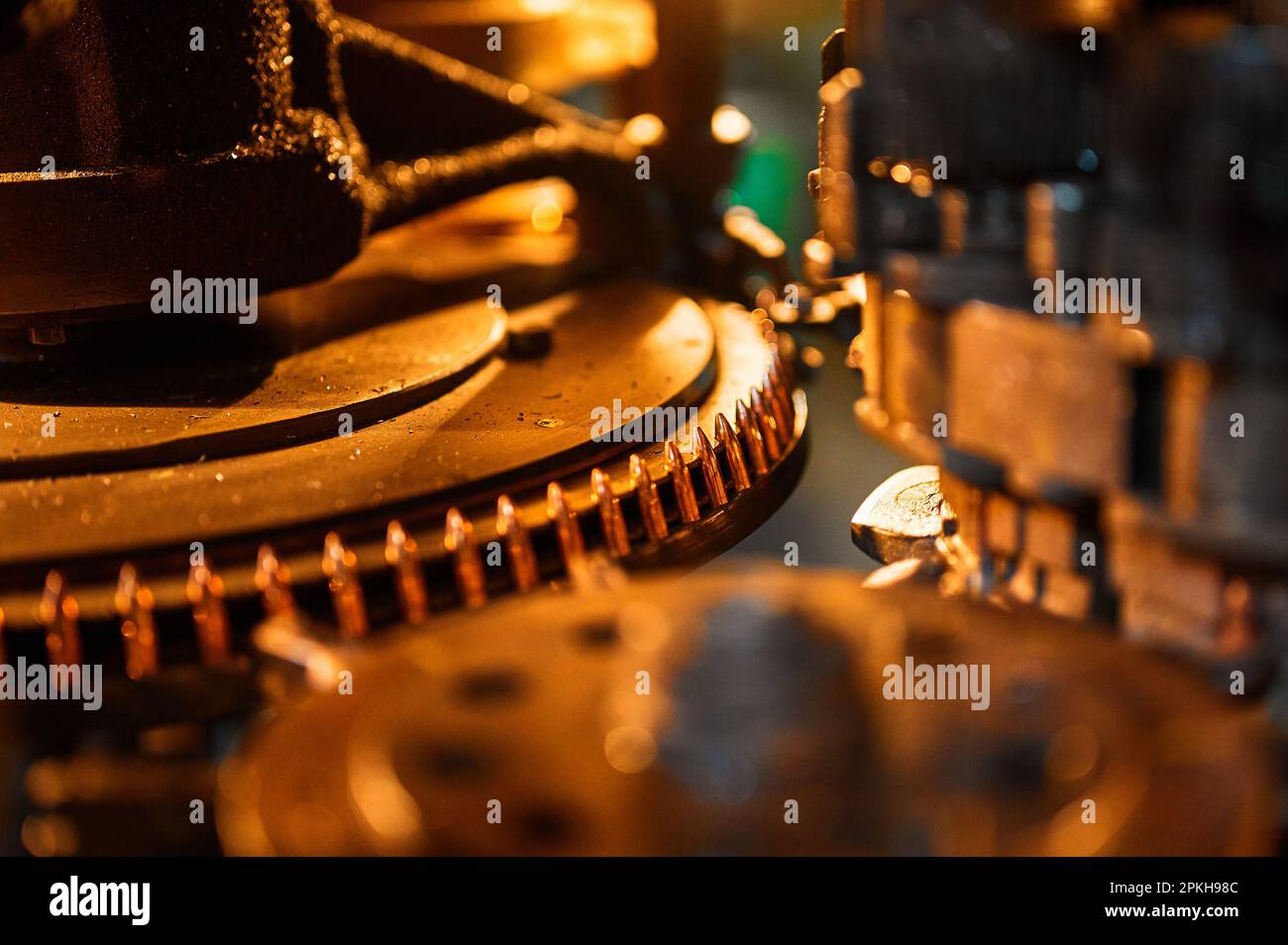 Copper bullets on production line part at weapon factory Stock Photo ...