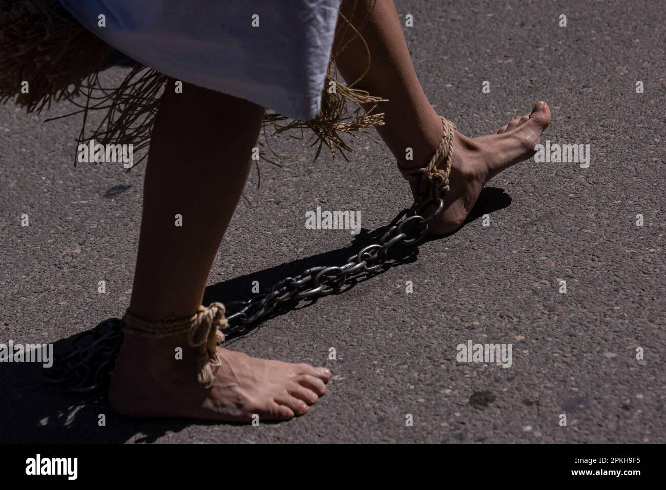 Picaos penitent walking with a metal chain on his feet during the ...
