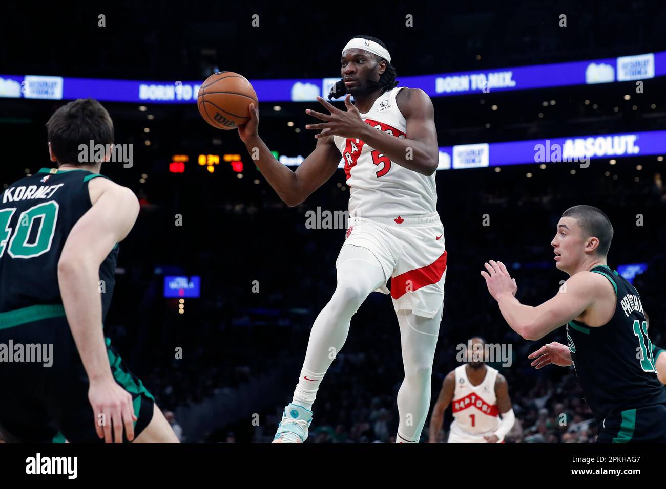 Toronto Raptors' Precious Achiuwa (5) passes off between Boston Celtics ...