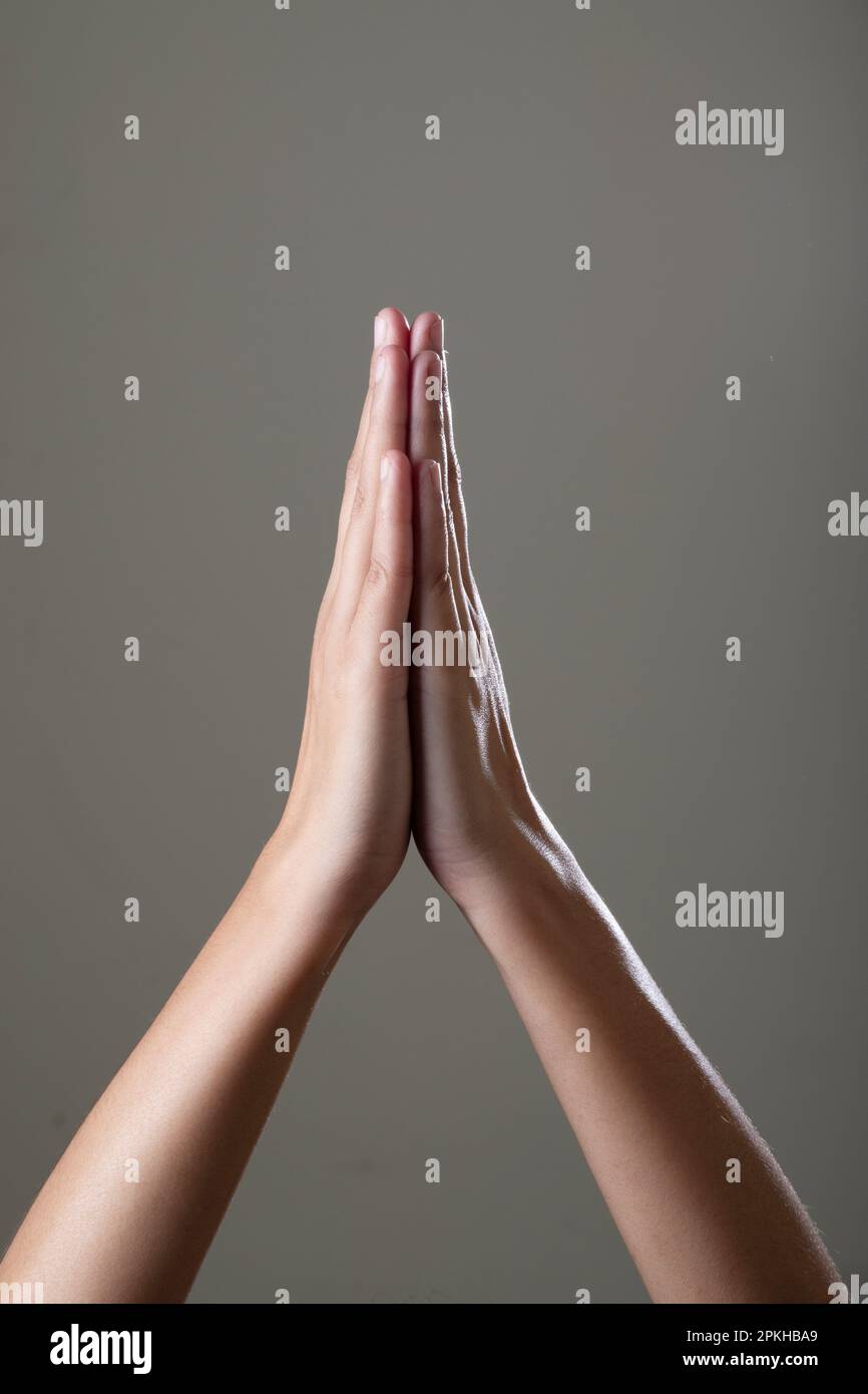 Namaste hand gesture on grey background Stock Photo - Alamy