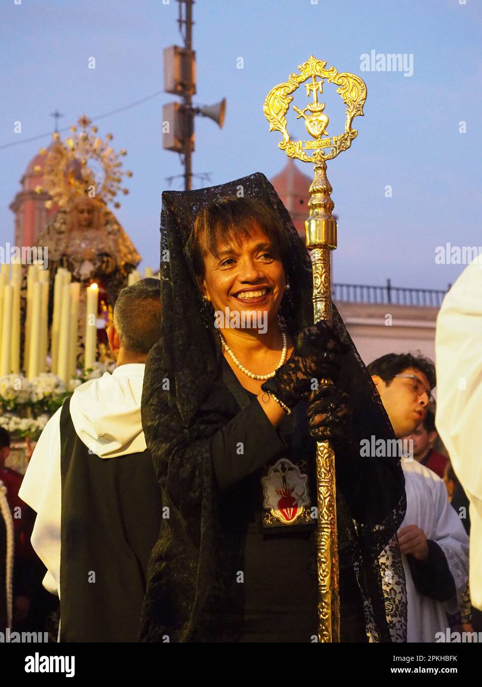 Black dressed female devotees wearing mantilla and comb, carrying ...