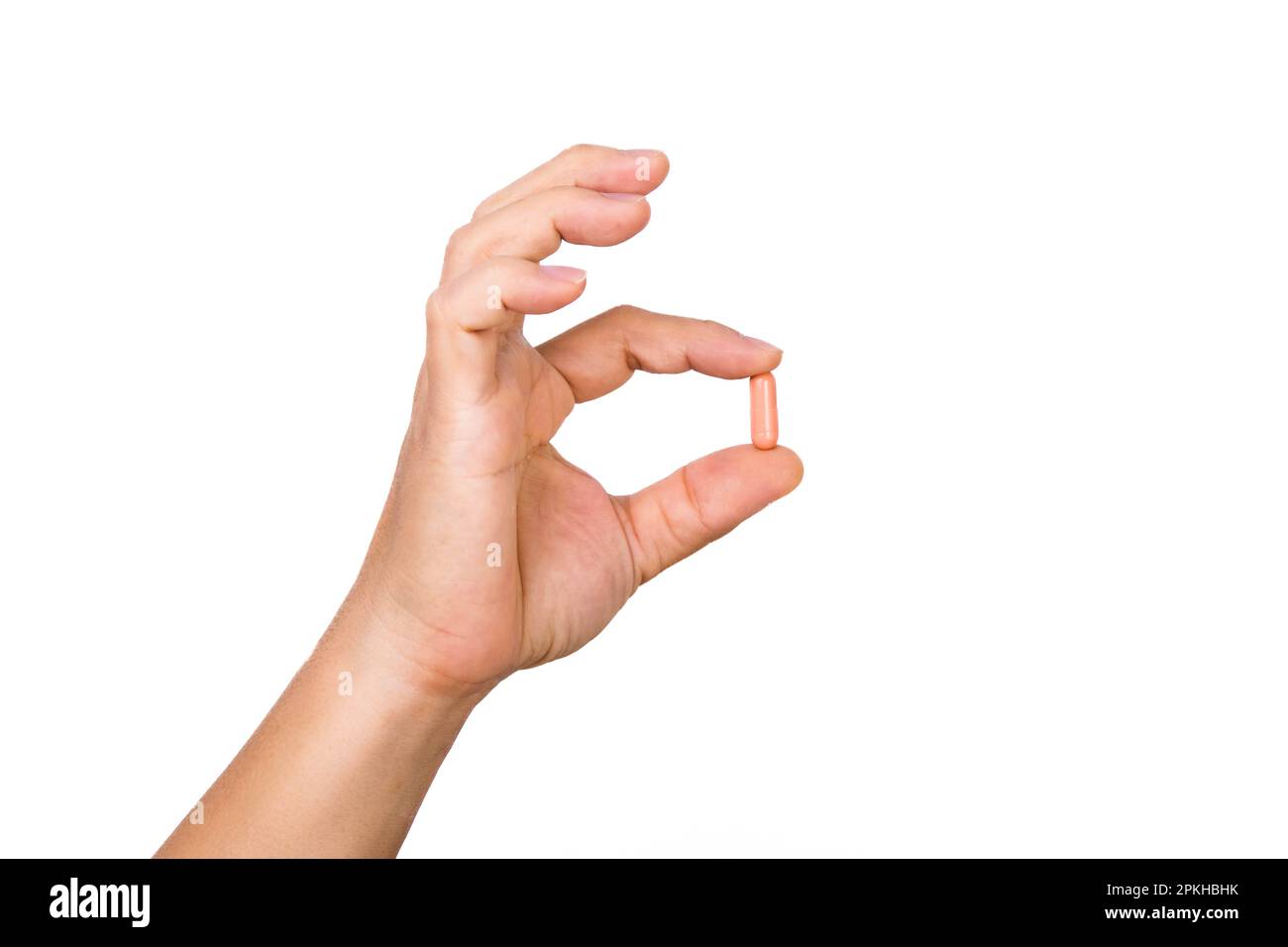 Hand holding a capsule or pill isolated on white background Stock Photo ...