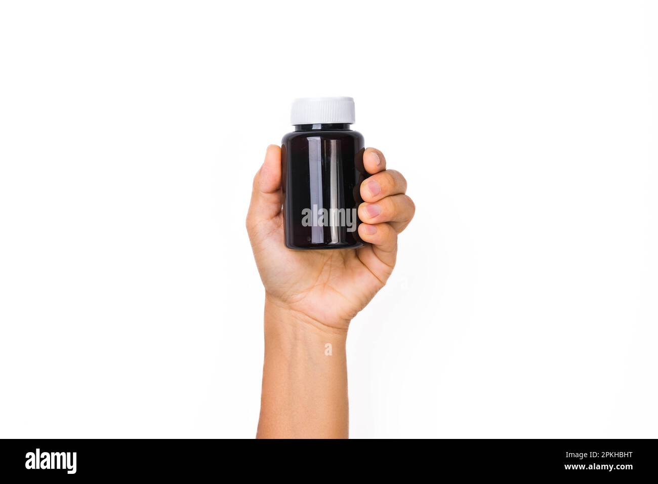 Female hand holding blank pill bottle isolated on white background ...