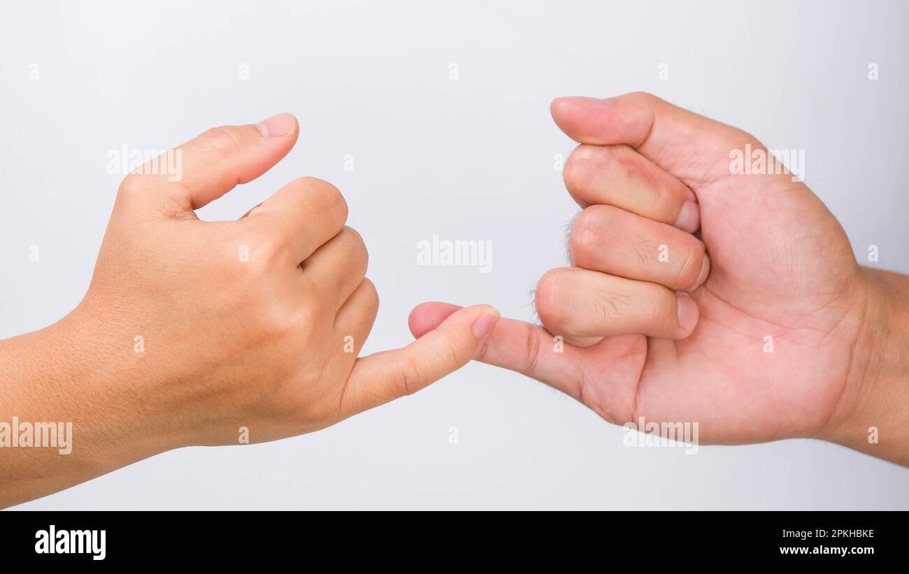 Man and woman making promise as a friendship concept or pinky swear ...