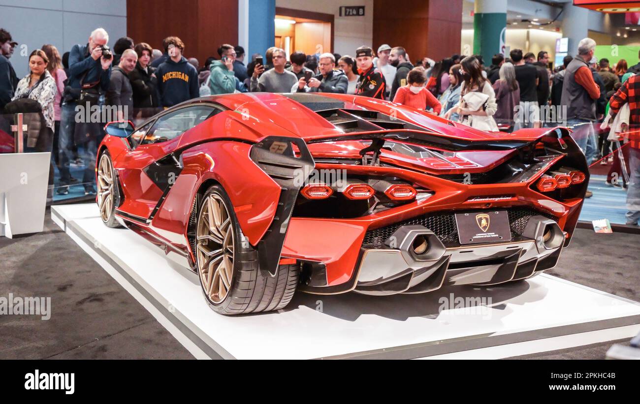 Crowds looking at new car models at Auto show. Lambordghini car on ...