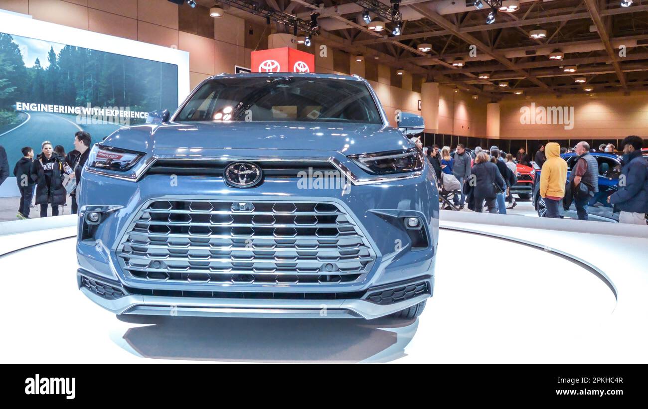Crowds looking at new car models at Auto show. Toyota car on display ...