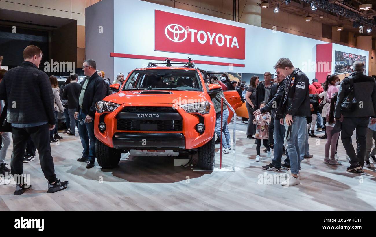 Crowds looking at new car models at Auto show. Toyota car on display ...