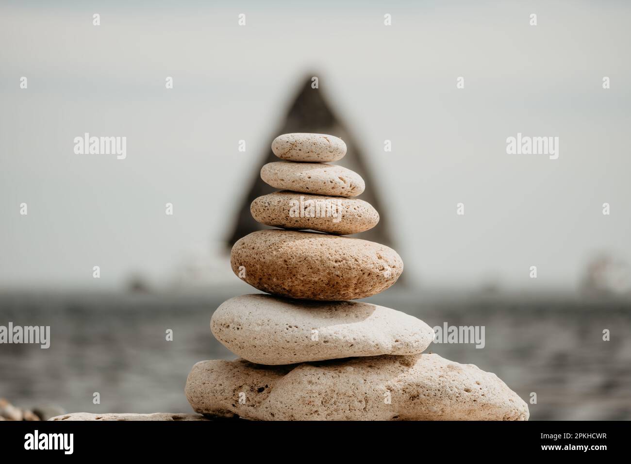 balanced rock pyramid on the pebbled beach is a study in harmony and ...