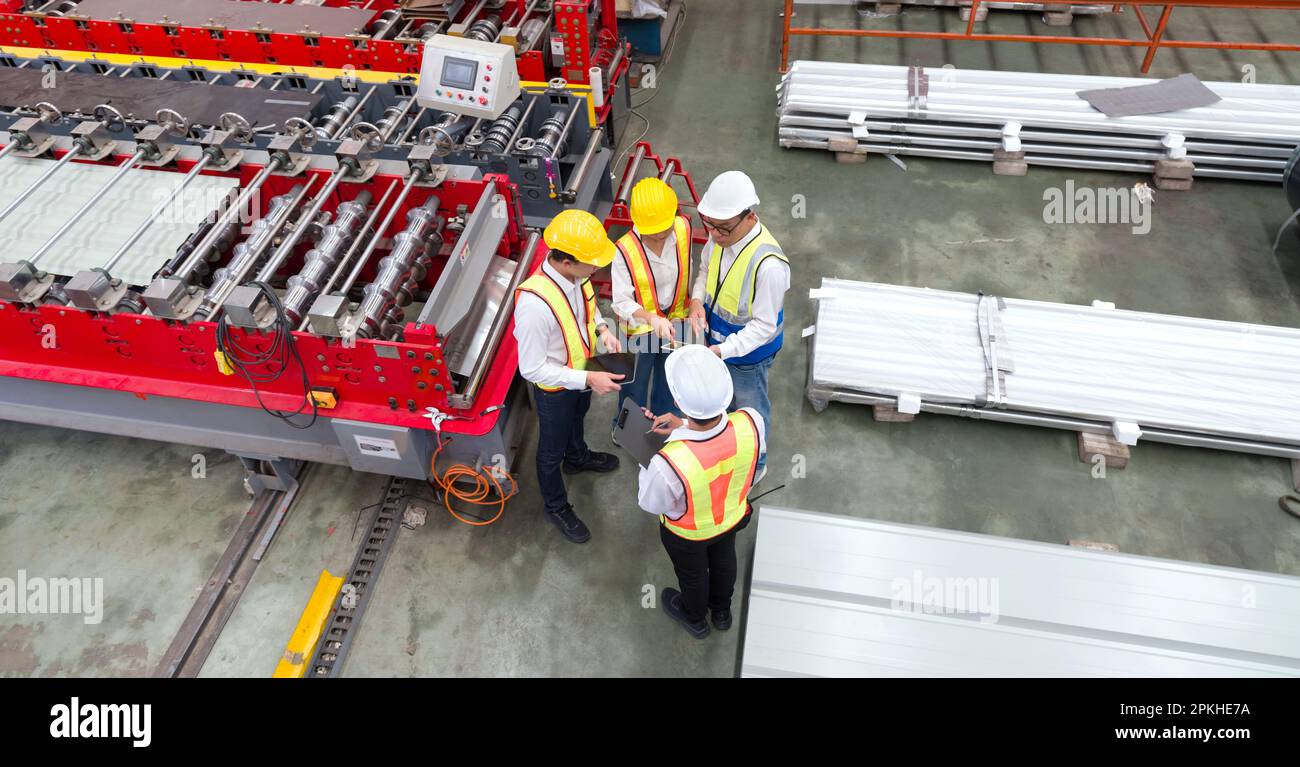 Senior engineer manager trains new employees within the metal sheet ...