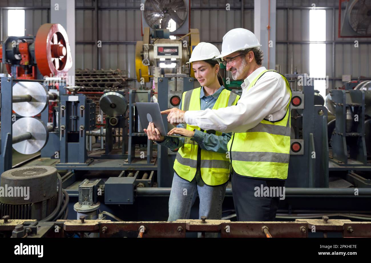 Senior engineer manager trains new employees within the metal sheet ...