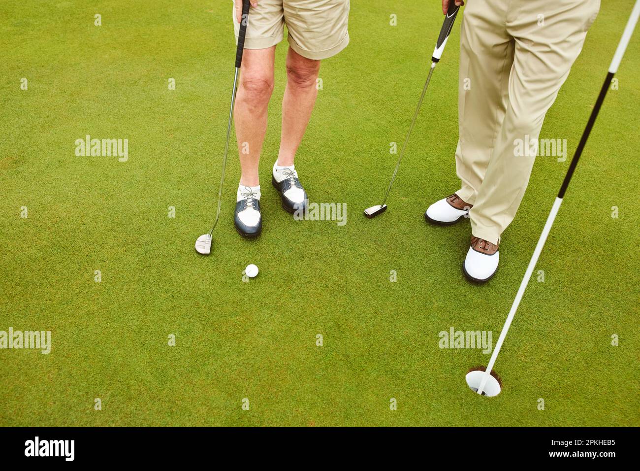 Getting closer to the hole. two unrcognizable people playing golf ...