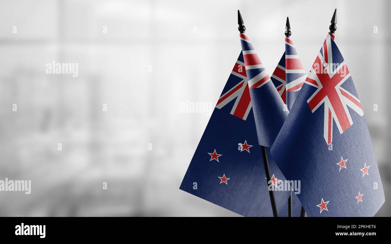 Small flags of the New Zealand on an abstract blurry background Stock ...
