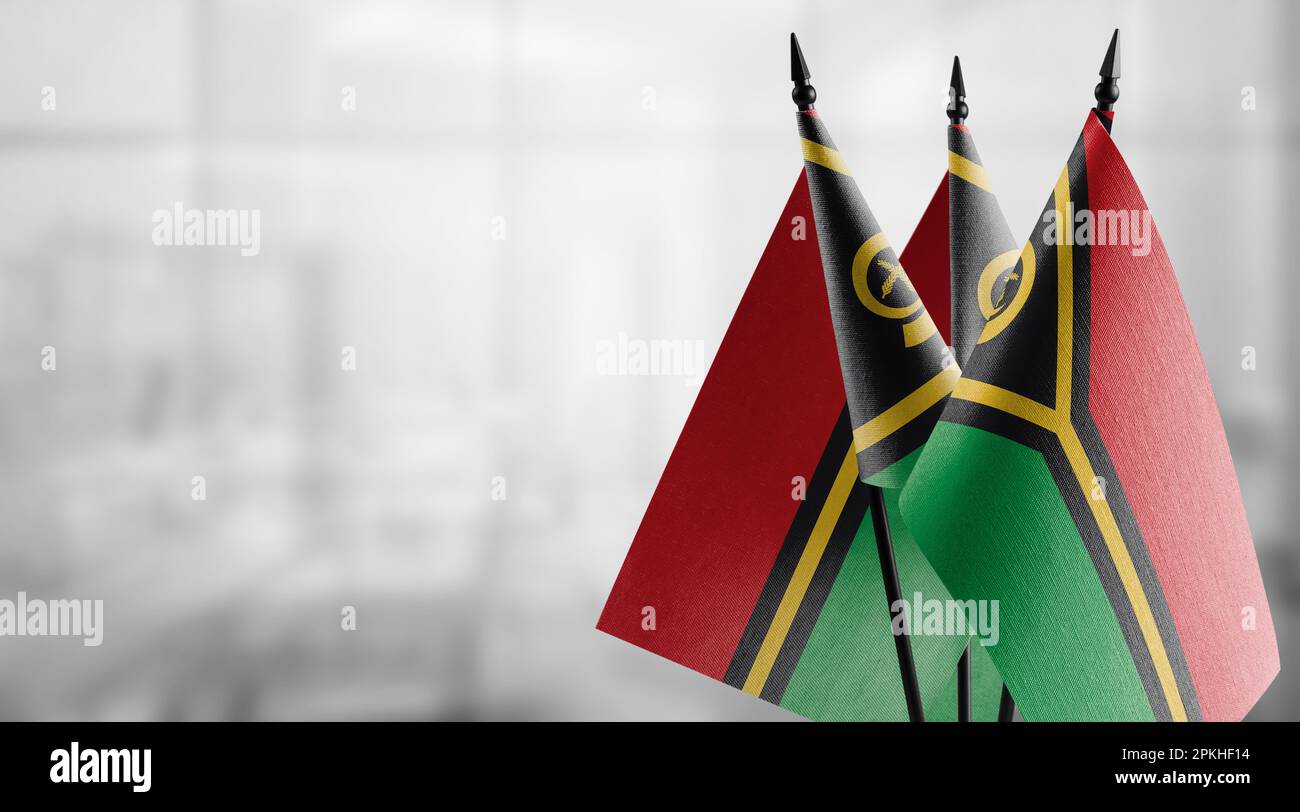 Small flags of the Vanuatu on an abstract blurry background Stock Photo ...