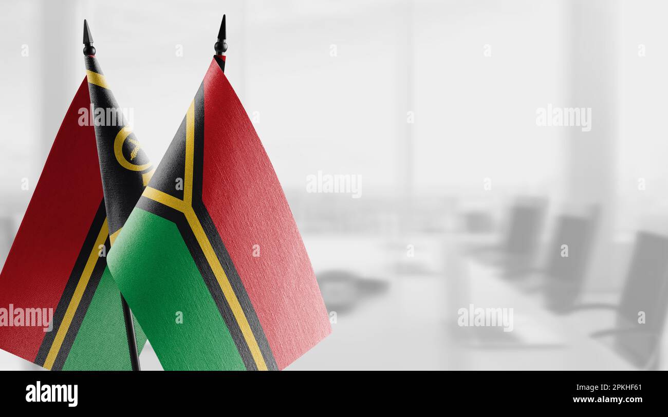Small flags of the Vanuatu on an abstract blurry background Stock Photo ...