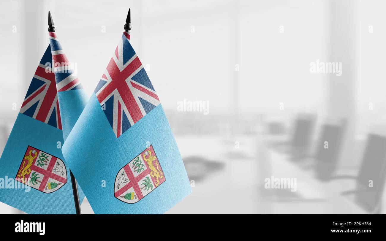 Small flags of the Fiji on an abstract blurry background Stock Photo ...