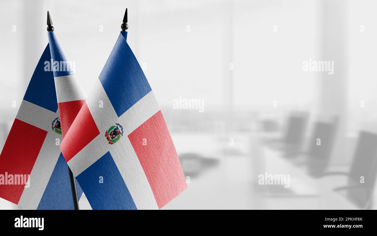 Small flags of the Dominicana on an abstract blurry background Stock ...