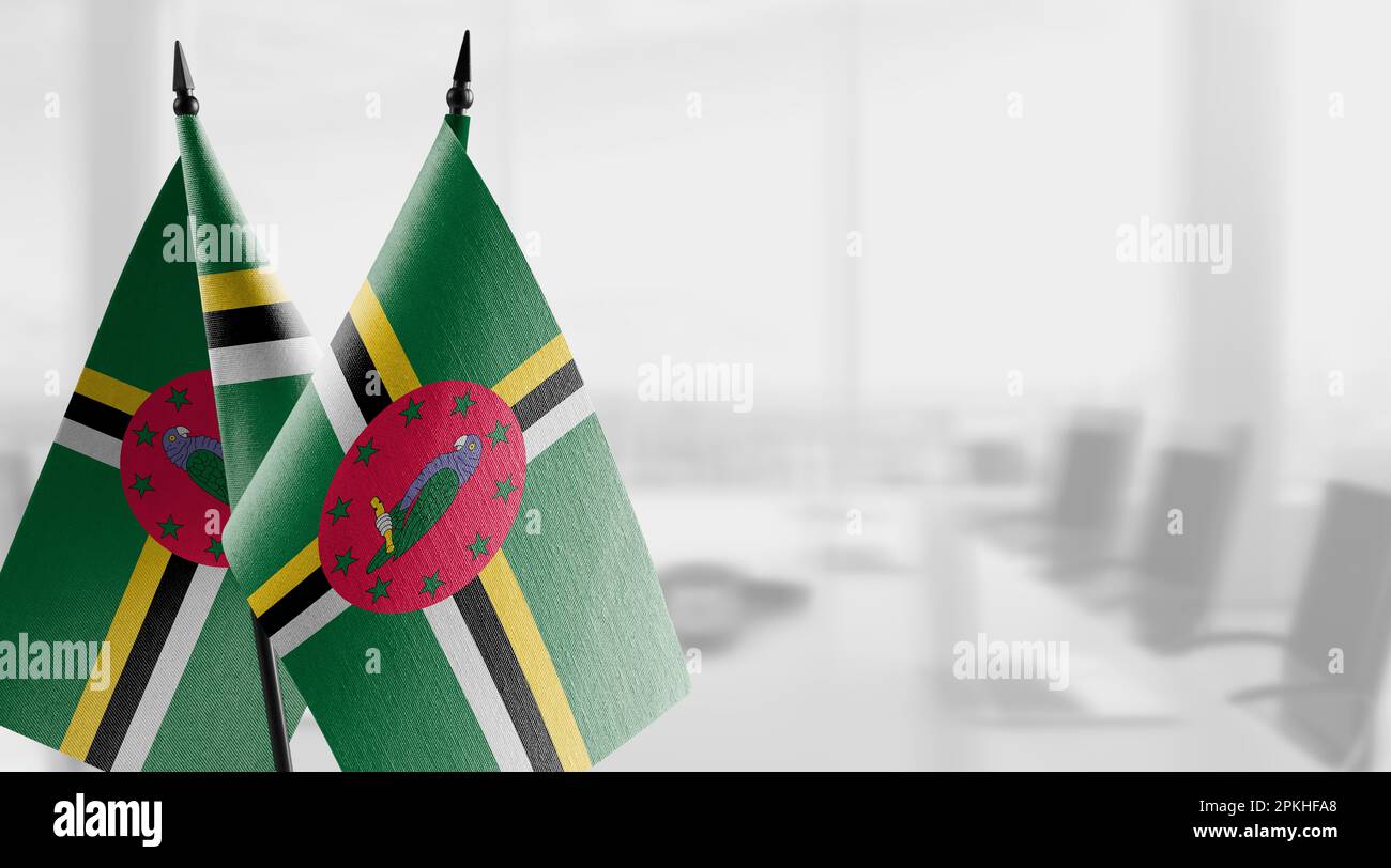 Small flags of the Dominica on an abstract blurry background Stock ...