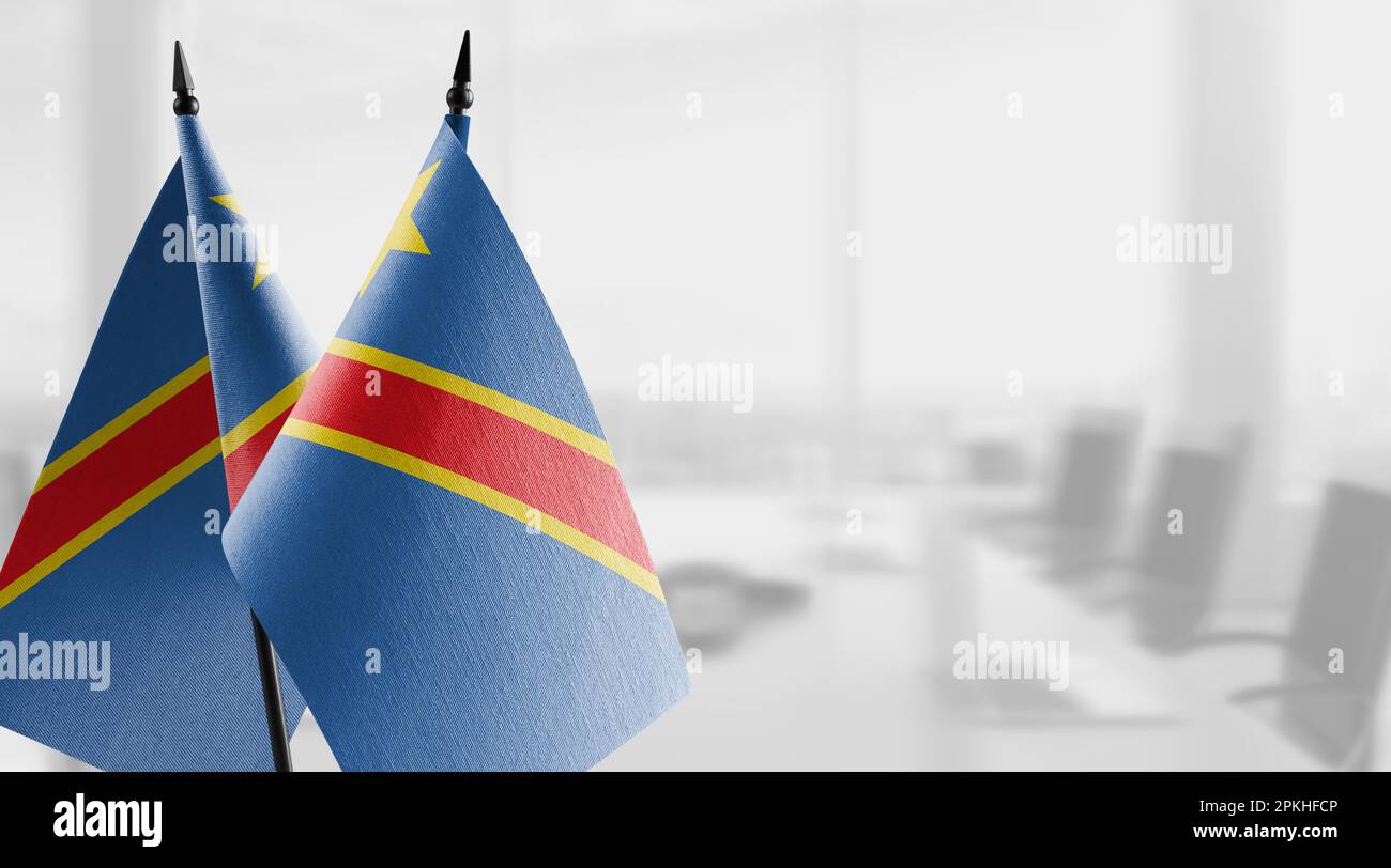 Small flags of the Democratic Republic of the Congo on an abstract ...