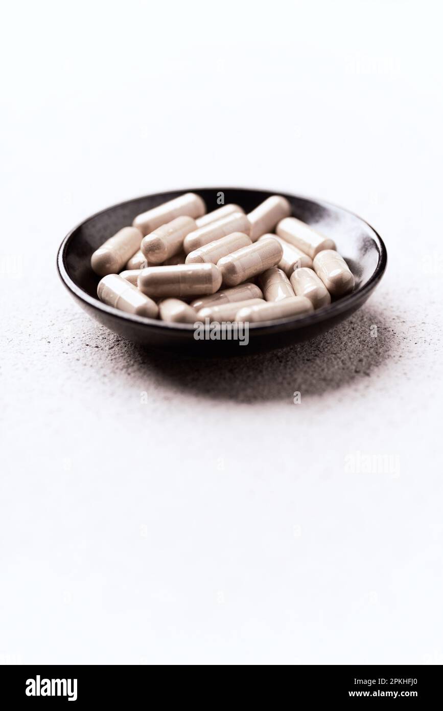 Ashwagandha (Withania somnifera) capsules. Bright paper background ...