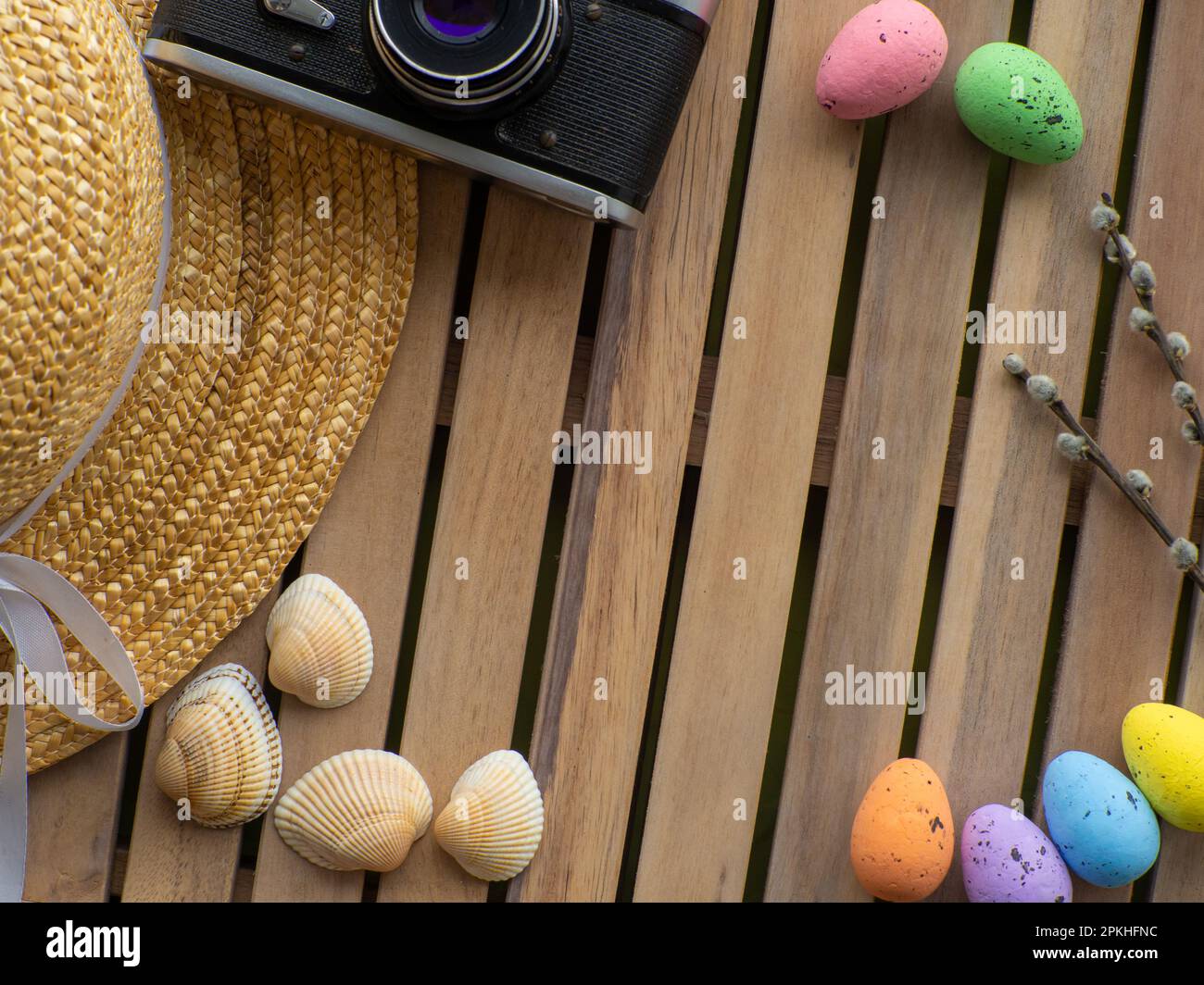 Easter background with straw hat, photo camera, colorful eggs and white ...