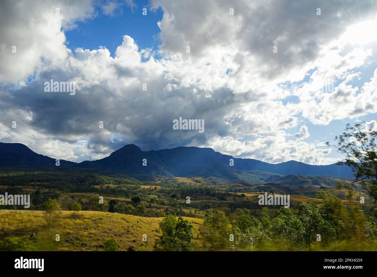 Dramatic dark clouds over distant blue mountain; Motion blur in the ...