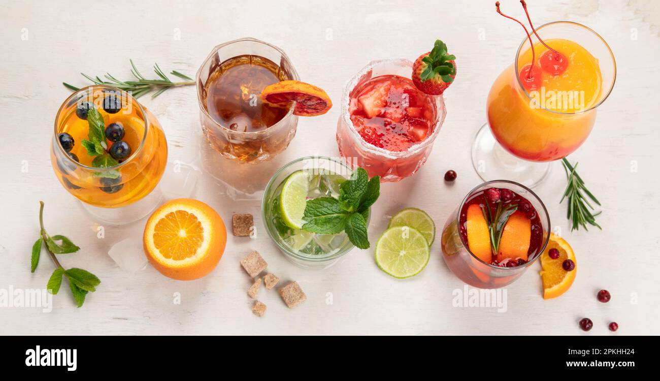 Different delicious cocktails on table. Alcoholic coctail with fruit ...