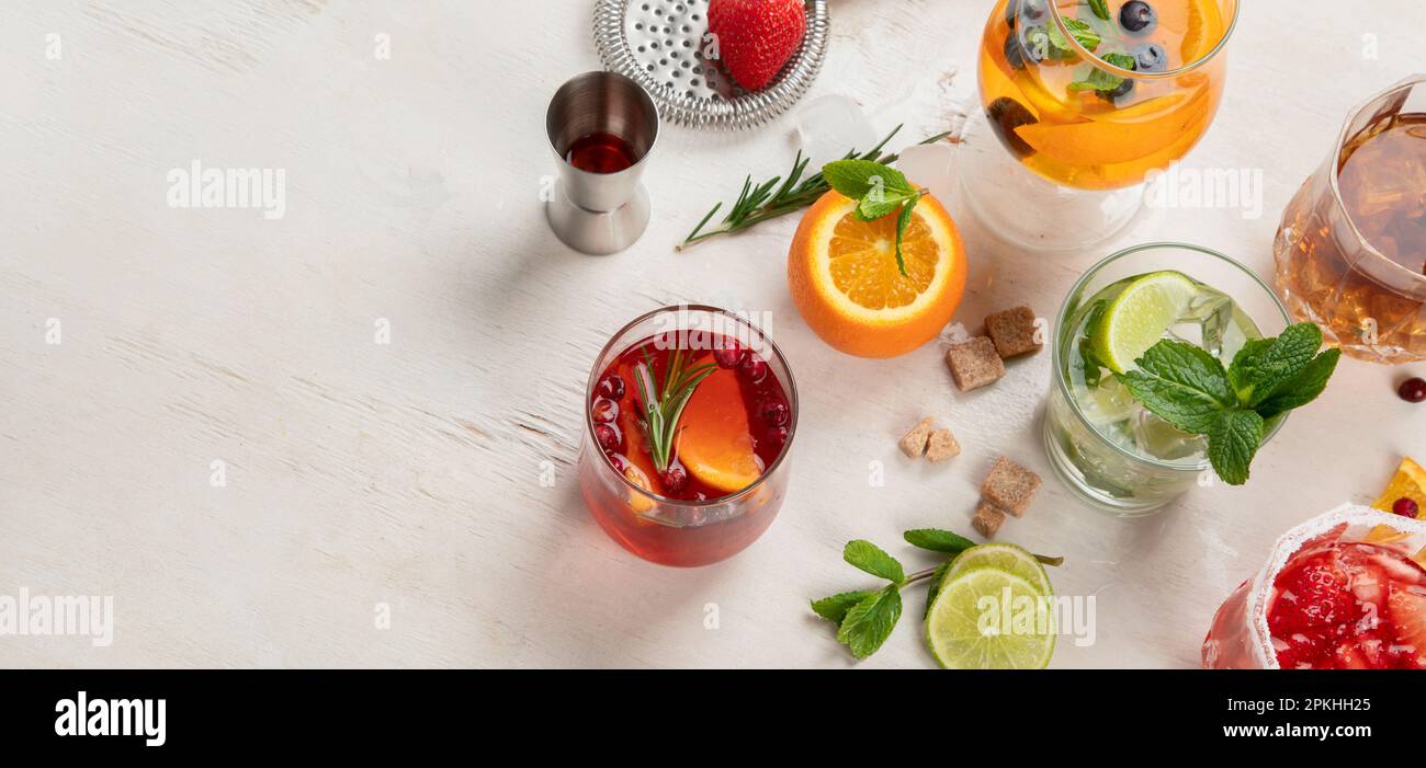Different delicious cocktails on table. Alcoholic coctail with fruit ...