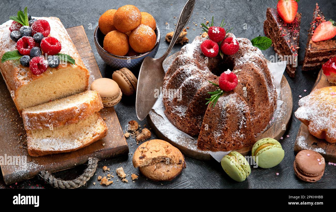 Different desserts on dark background. Delicious sweet dessert table ...