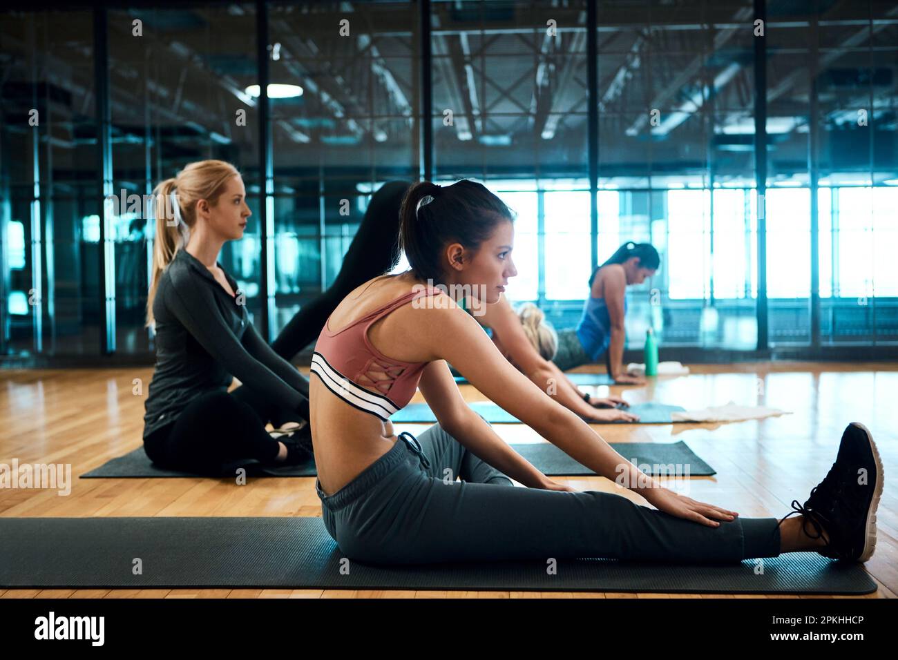 Getting ready for yoga. a group of attractive young women stretching ...